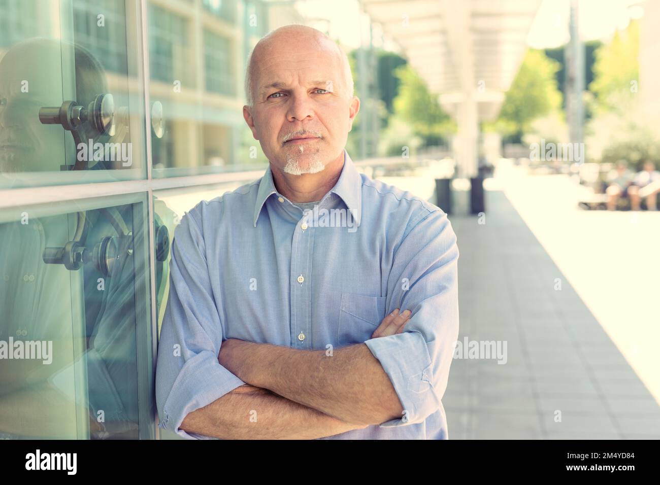 Senior with folded arms and a strong expression. Exudes confidence and ...