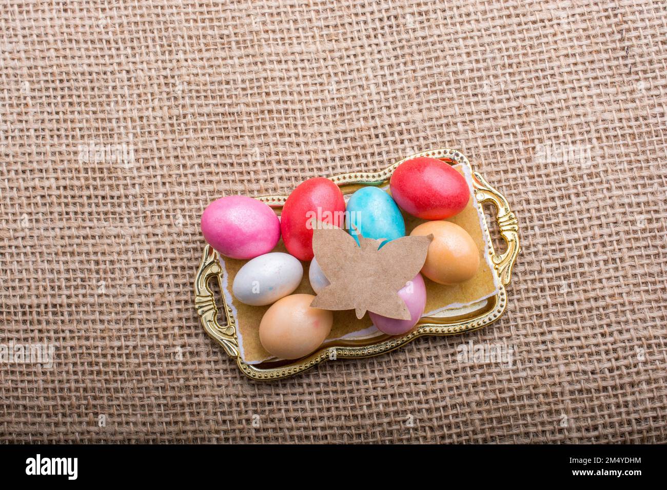 Paper Butterfly on Colorful candy sweets in tray Stock Photo - Alamy