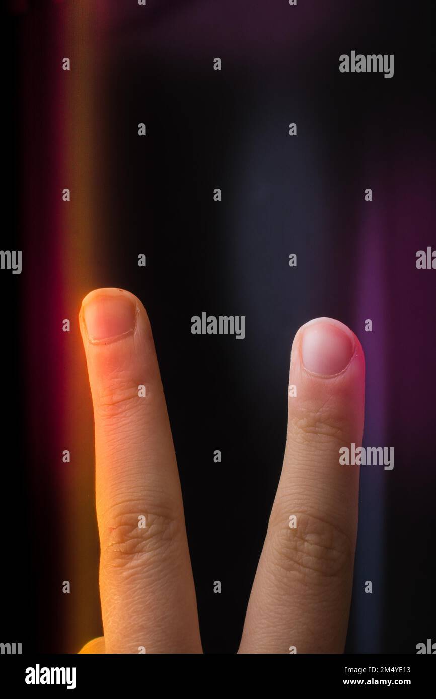 The sign of victory and peace in black background Stock Photo - Alamy