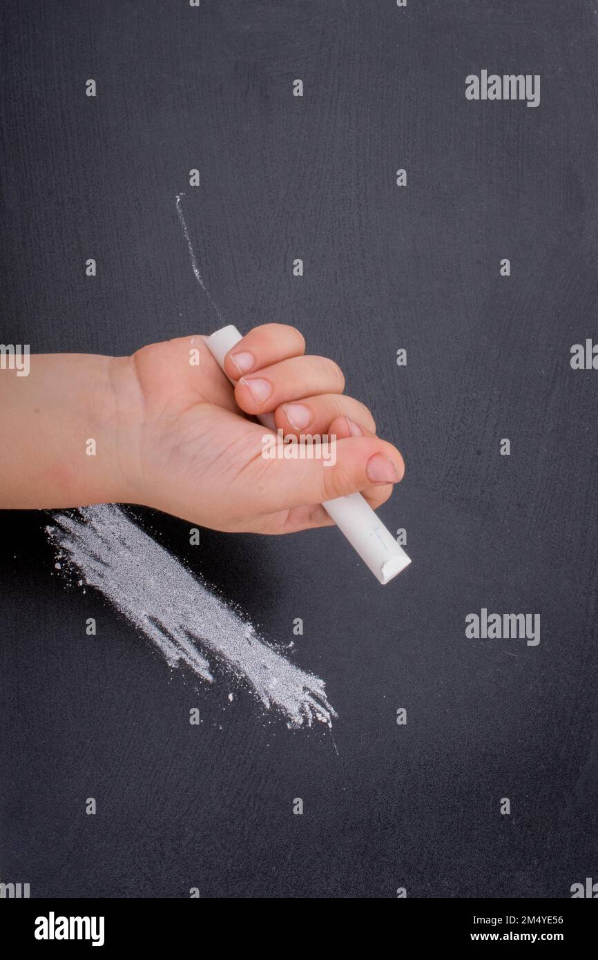 Hand holding white chalk and black board Stock Photo - Alamy