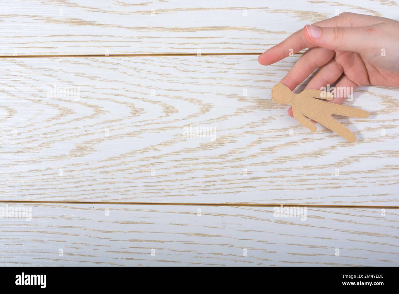 Man shape cut out of paper in hand in the view Stock Photo - Alamy