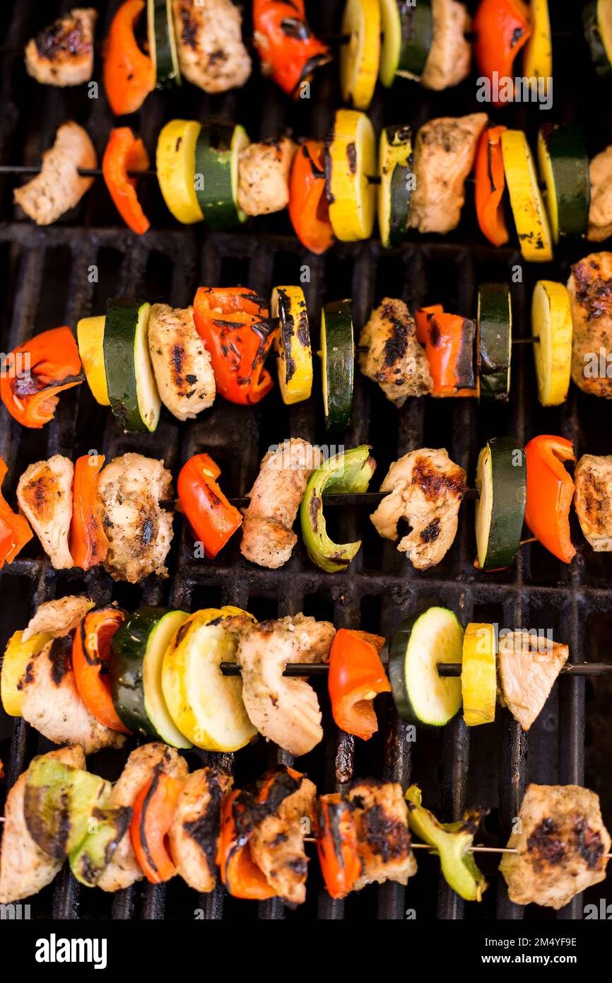 A vertical shot of vegetable and chicken kabobs on a grill Stock Photo - Alamy