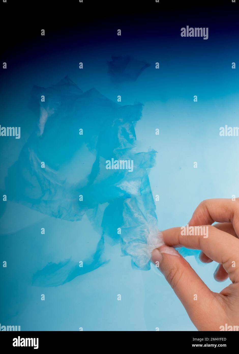 Hand holding wodden puppet Pinocchio on in blue water Stock Photo - Alamy