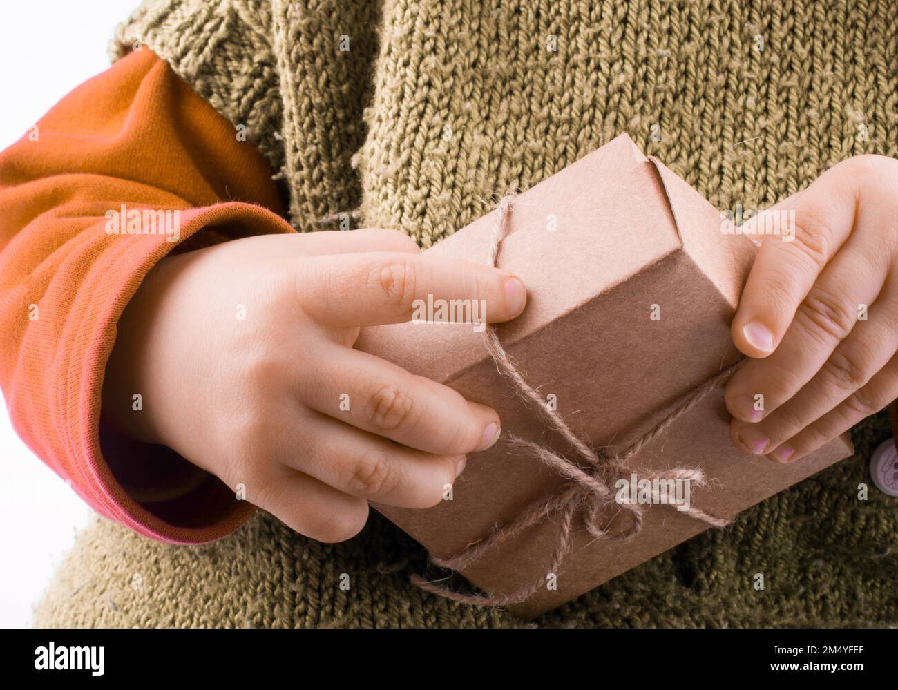 Baby holding a wrapped gift box on white background Stock Photo - Alamy