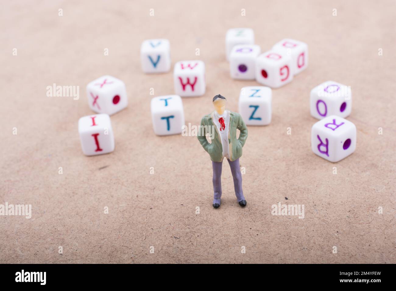 Figurine standing in front of the colorful alphabet letter cubes Stock ...
