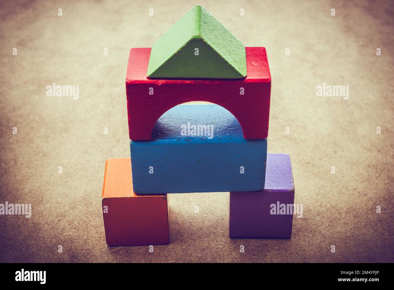 House shape formed out of building blocks on a brown background Stock ...