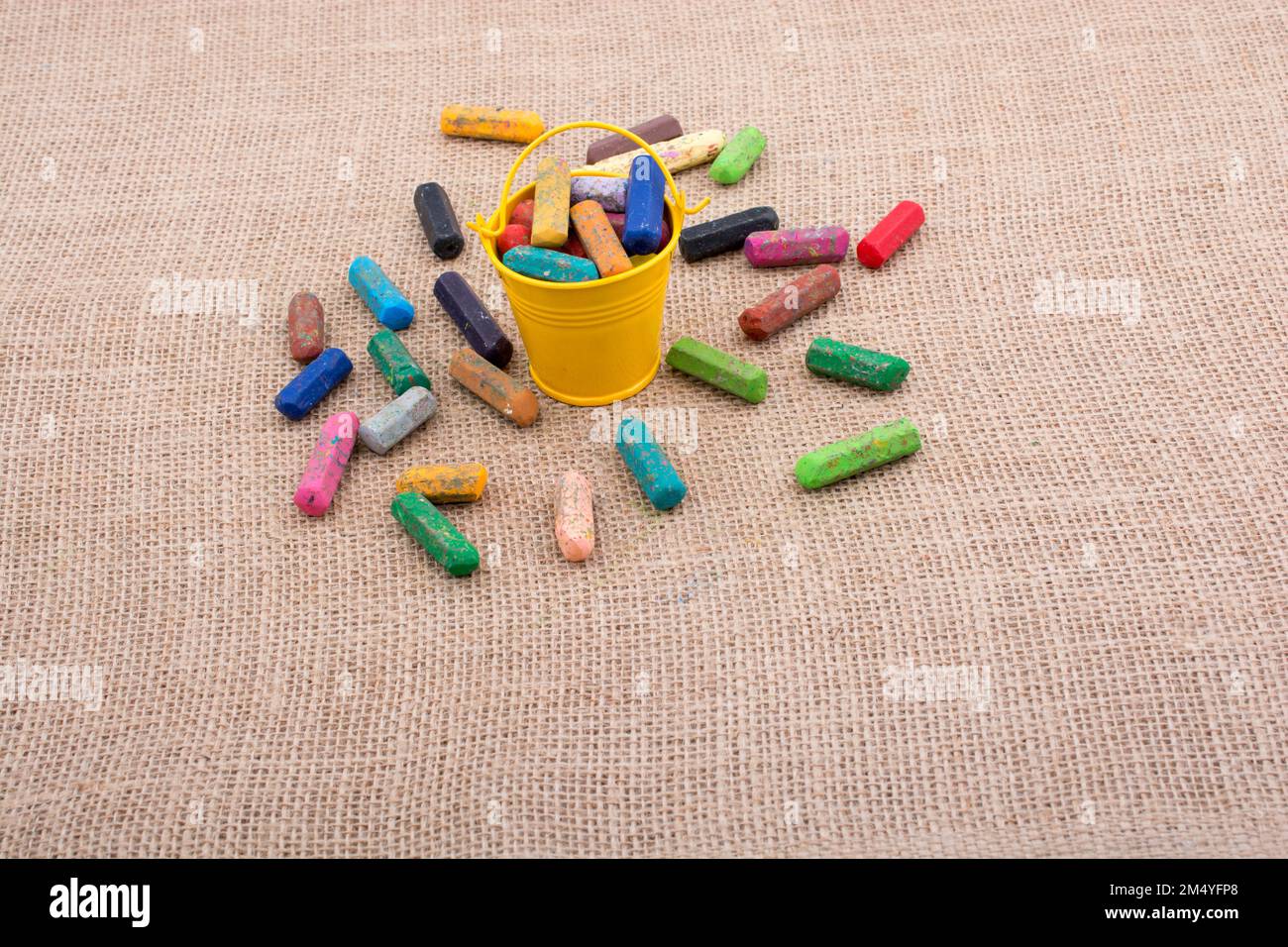 Crayons of various color in a bucket on a canvas Stock Photo - Alamy