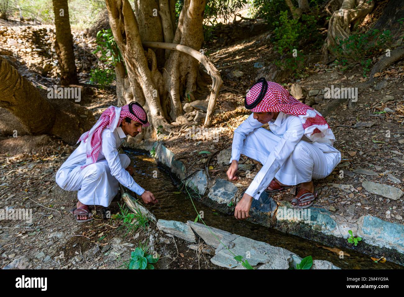 Young men washing in a spring, Zee Al-Ayn historic mountain village ...