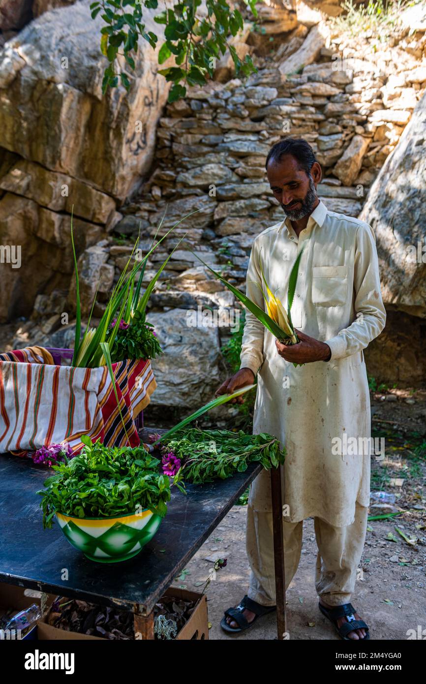 Man selling flowers, Zee Al-Ayn historic mountain village, Kingdom of ...