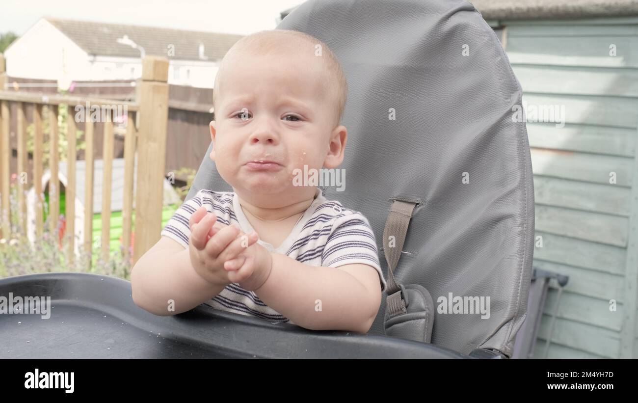 Woman feeding Tired child with spoon. Mom feed crying Sad baby Boy with ...