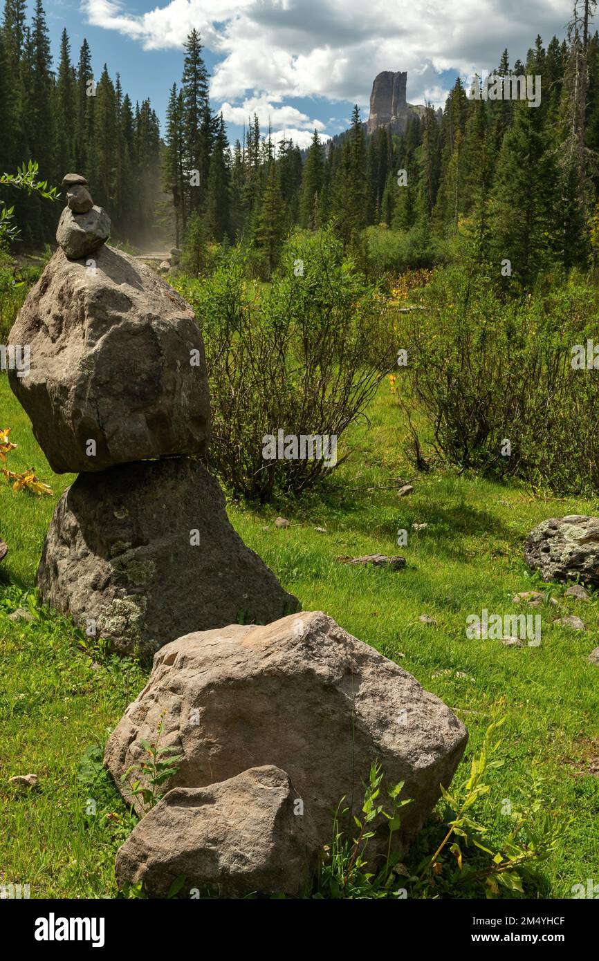 Chimney Rock along Owl Creek Pass, seen behind stacked rocks near the ...
