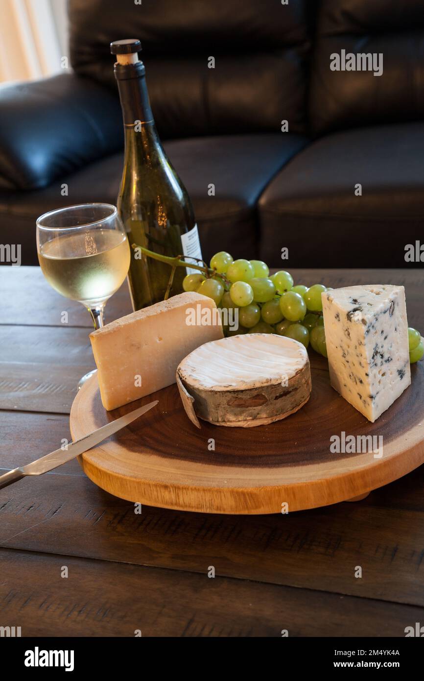 Cheese plate and wine including chardonnay, gourmet crackers, a washed ...