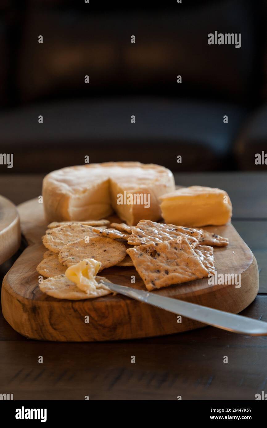 Cheese plate and wine including chardonnay, gourmet crackers, a washed ...