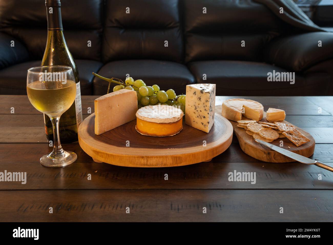 Cheese plate and wine including chardonnay, gourmet crackers, a washed ...