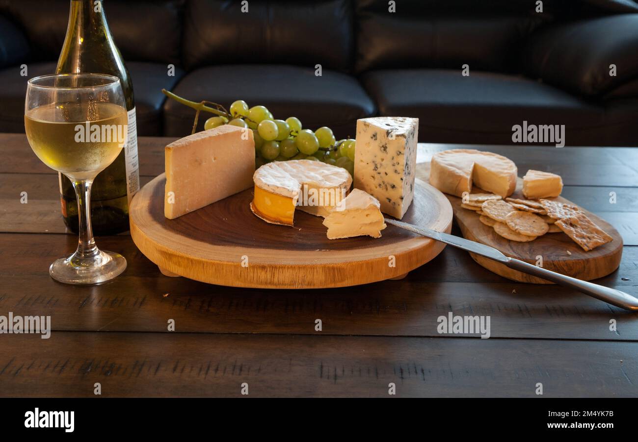 Cheese plate and wine including chardonnay, gourmet crackers, a washed ...