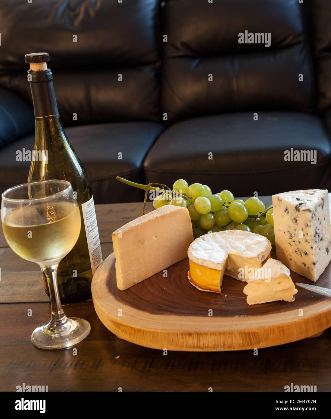Cheese plate and wine including chardonnay, gourmet crackers, a washed ...