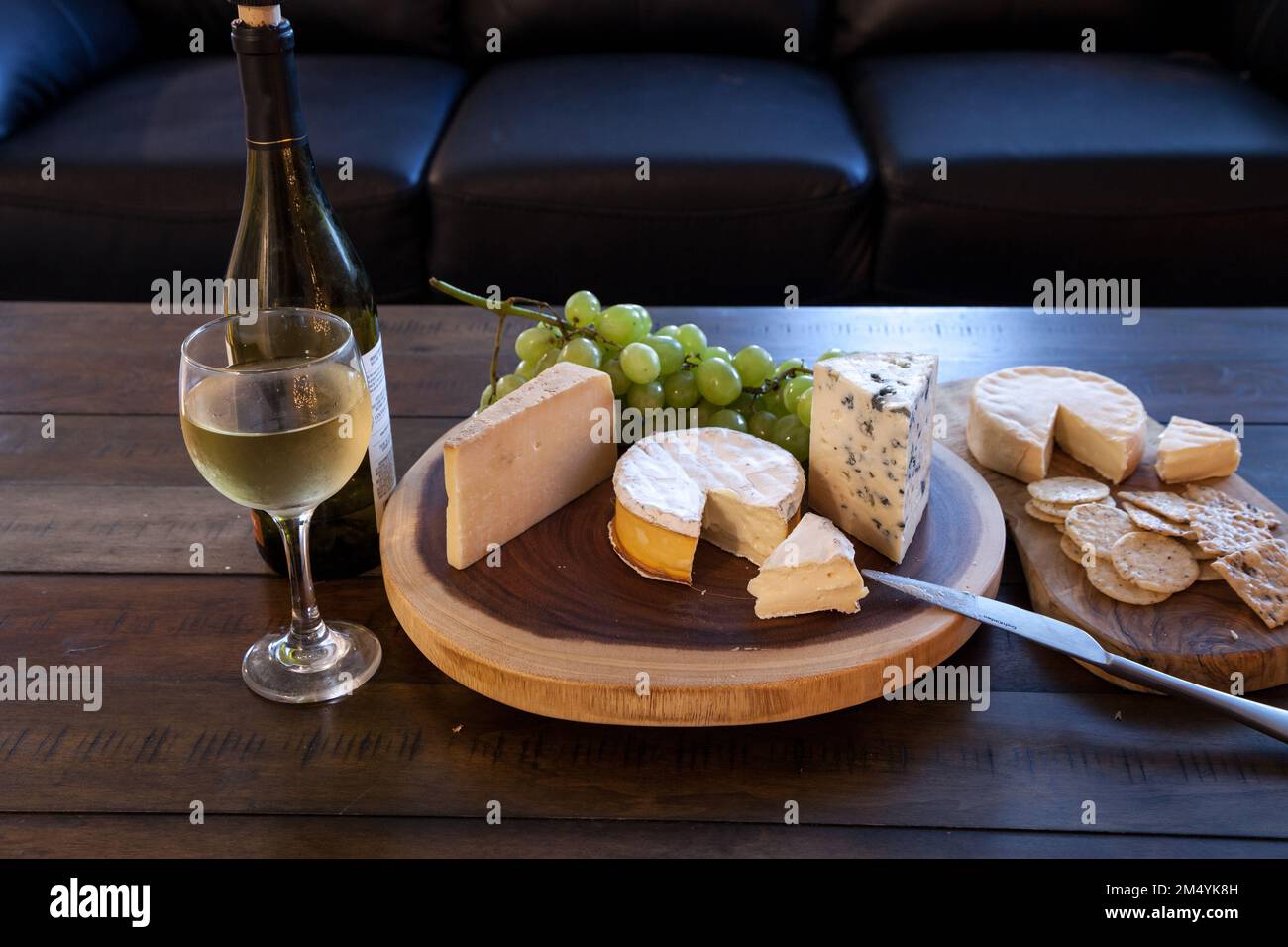 Cheese plate and wine including chardonnay, gourmet crackers, a washed ...