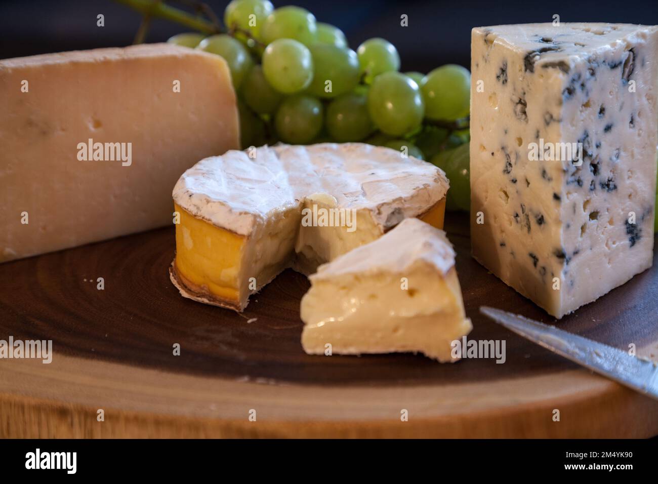Cheese plate and wine including chardonnay, gourmet crackers, a washed ...