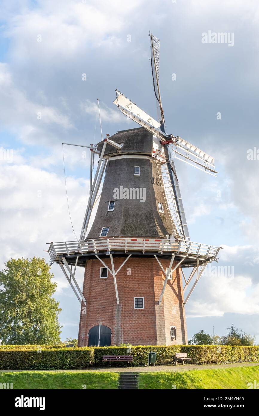 A vertical view of an old windmill before a cloudy sky in Sumar - De ...