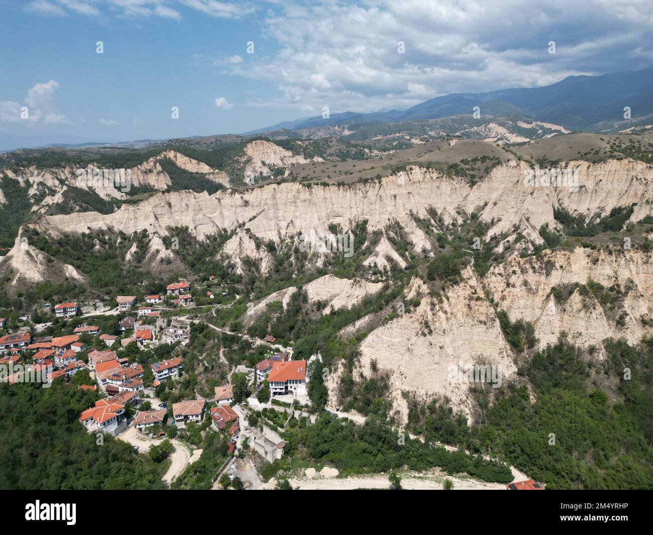A bird's eye view of residential houses in a valley between cliffs ...