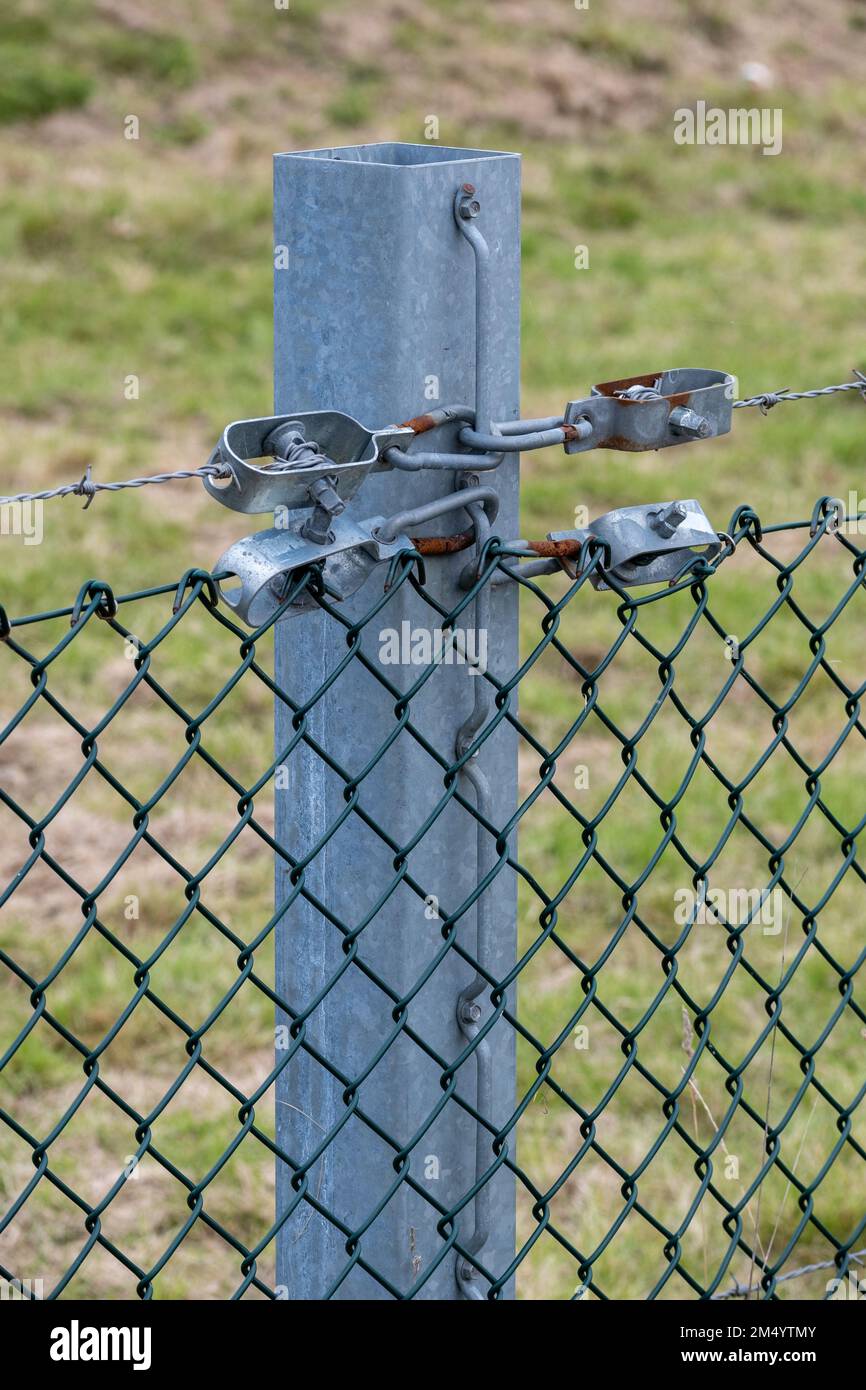 A vertical detailed view of a steel wire fence before a field Stock ...