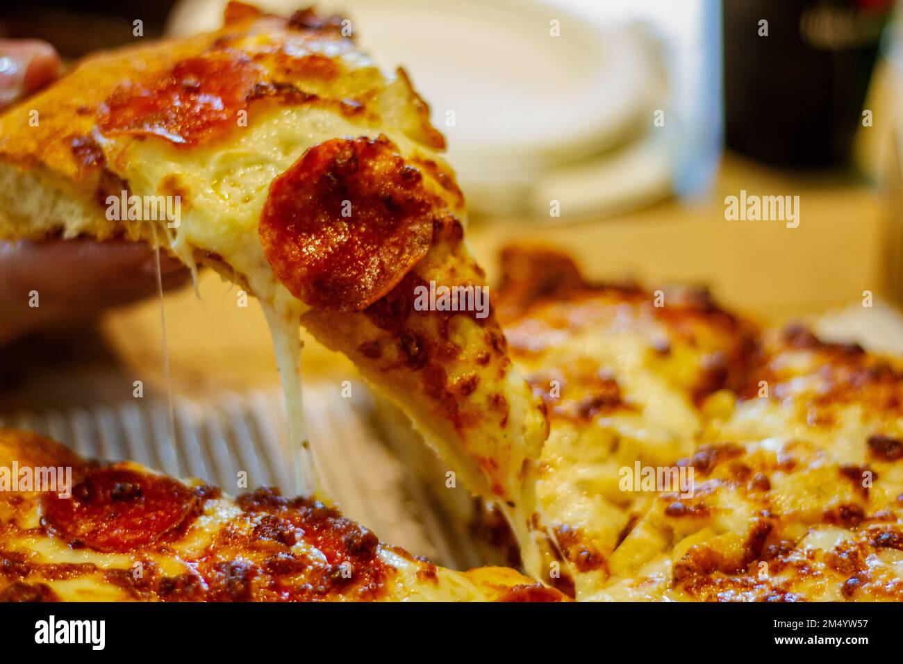 wedge of pepperoni pizza separated from the rest of the pizza Stock ...