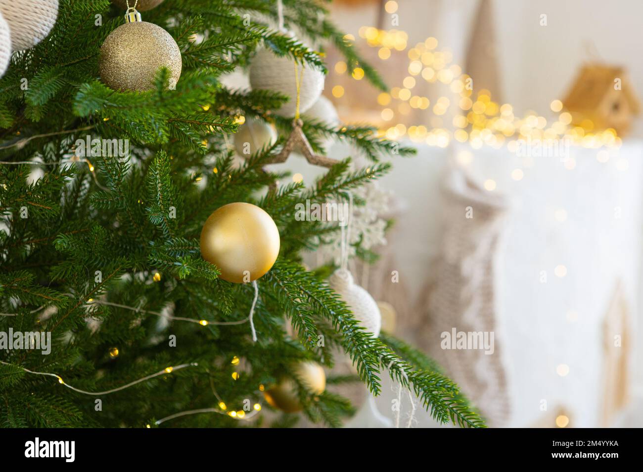 Christmas tree decorated with golden ball toys on a blurry, sparkling ...