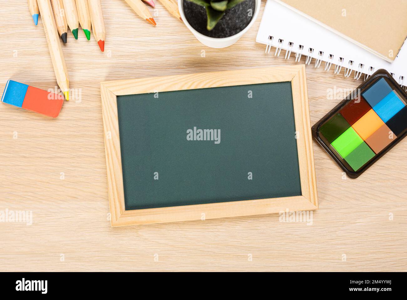 School chalkboard mockup on work desk. Composition of a student's desk ...