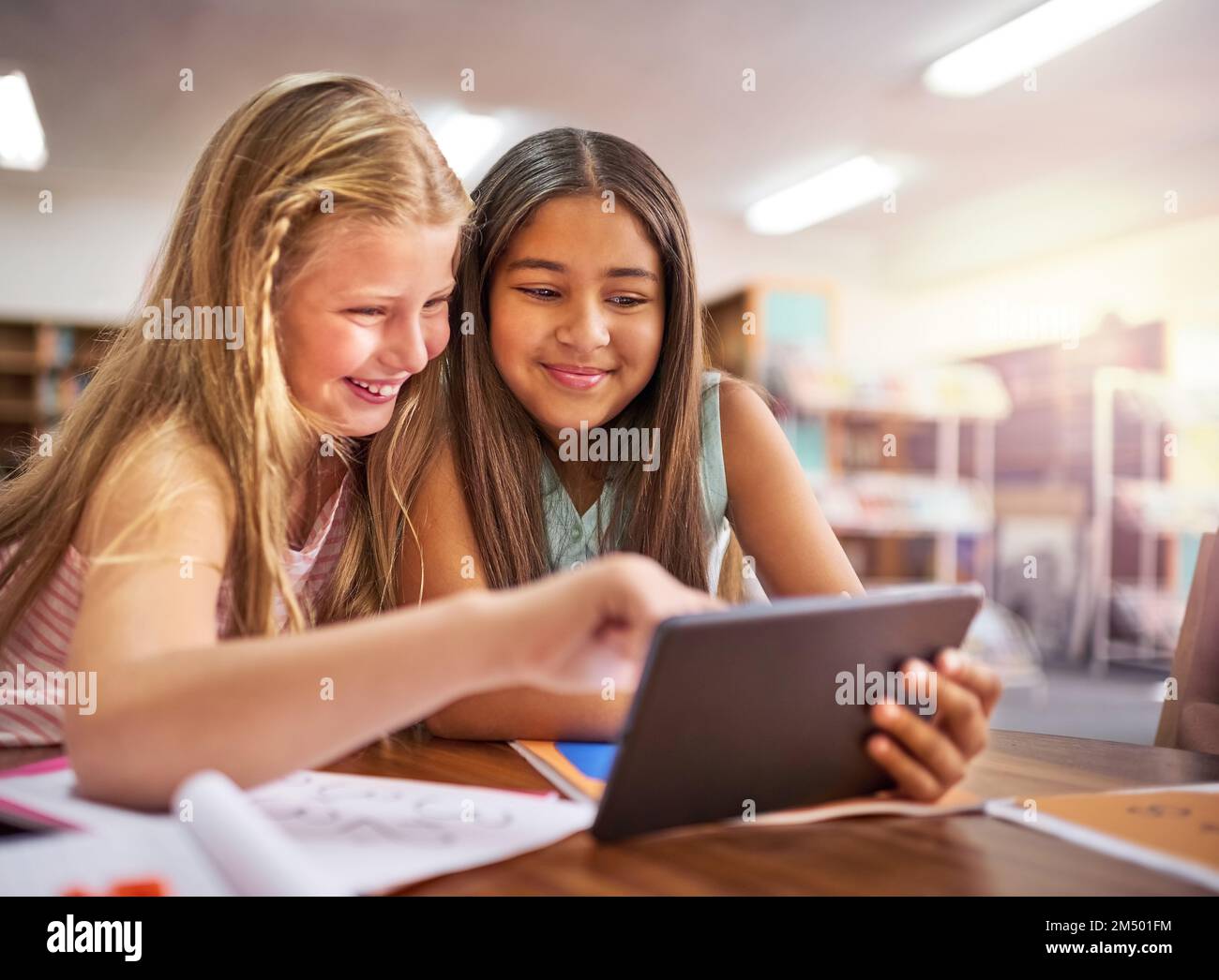 Enhancing the learning experience. two young girls using a digital ...