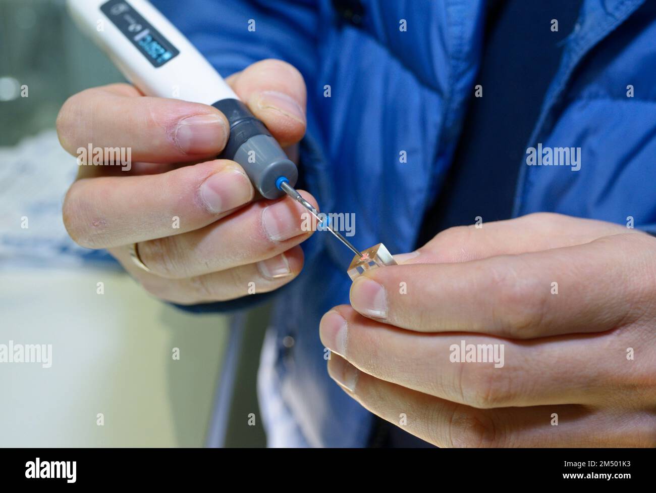 Doctor hands working with root canal filling injector Stock Photo - Alamy