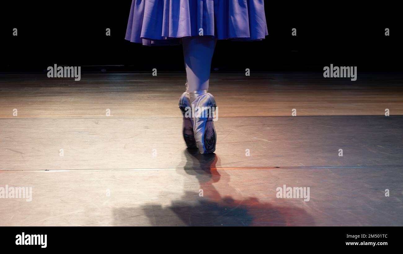 Feet of a ballerina doing a ballet step on stage Stock Photo - Alamy