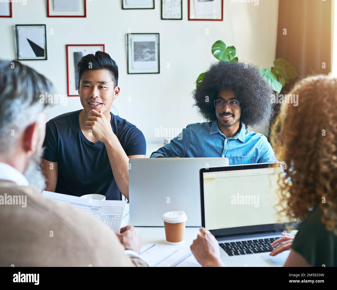 Combining their creative know-how as a team. a group of businesspeople ...