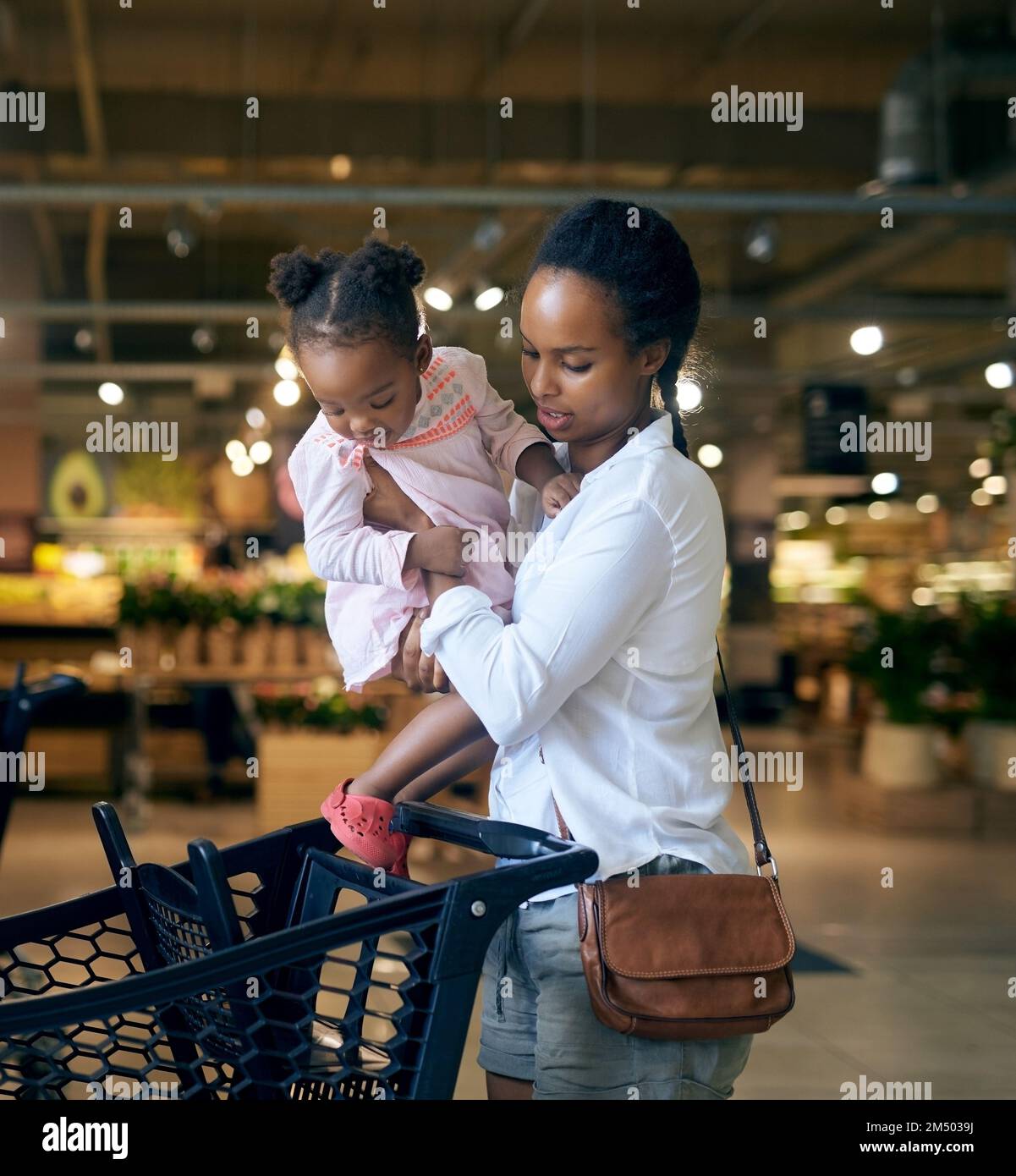 You sit right there. a young mother doing grocery shopping with her ...