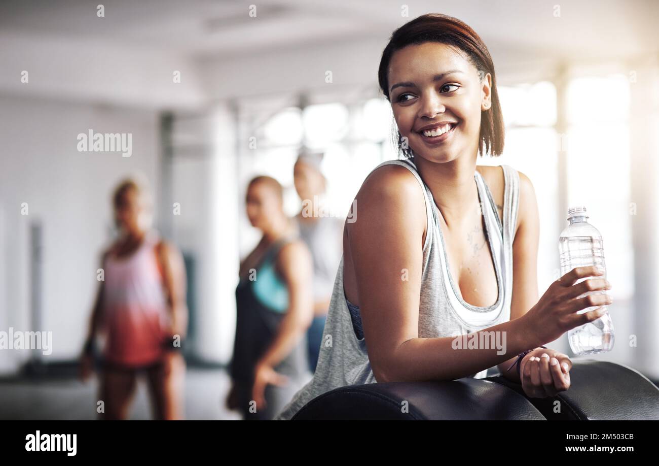 Drinking water during my break. an attractive young woman taking a ...