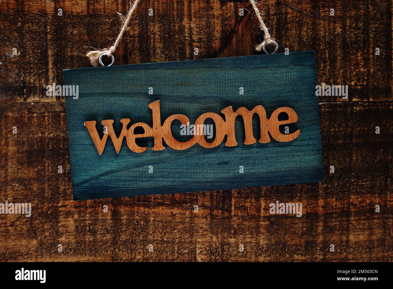 Wooden Welcome sign Hanging on space wooden background Stock Photo - Alamy