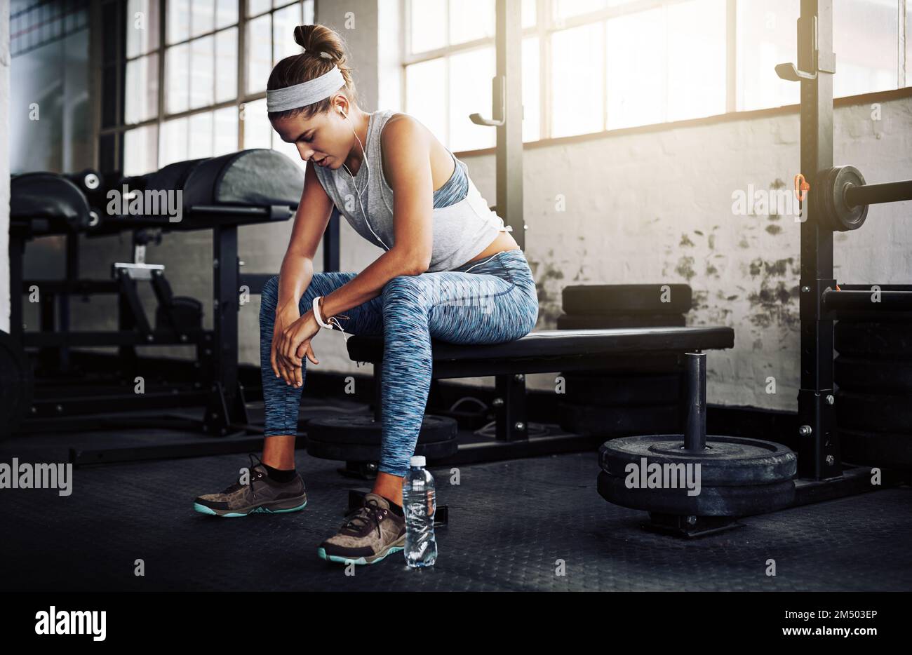 That was an intense workout. an attractive young woman taking a break ...