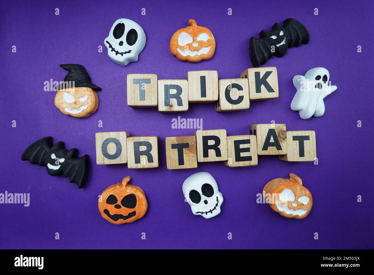 Halloween concept flat lay Trick or Treat alphabet letters on purple ...