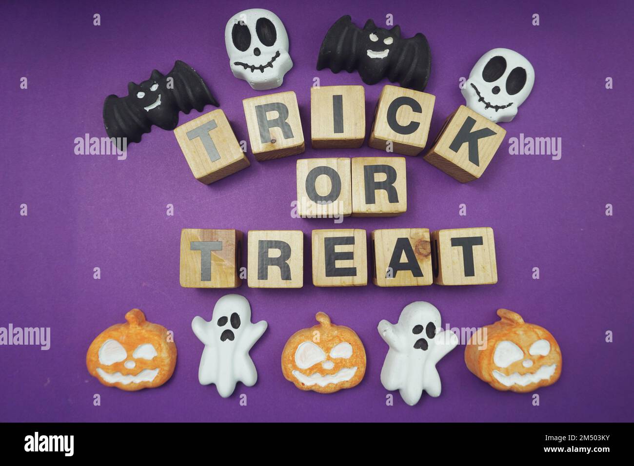 Halloween concept flat lay Trick or Treat alphabet letters on purple ...