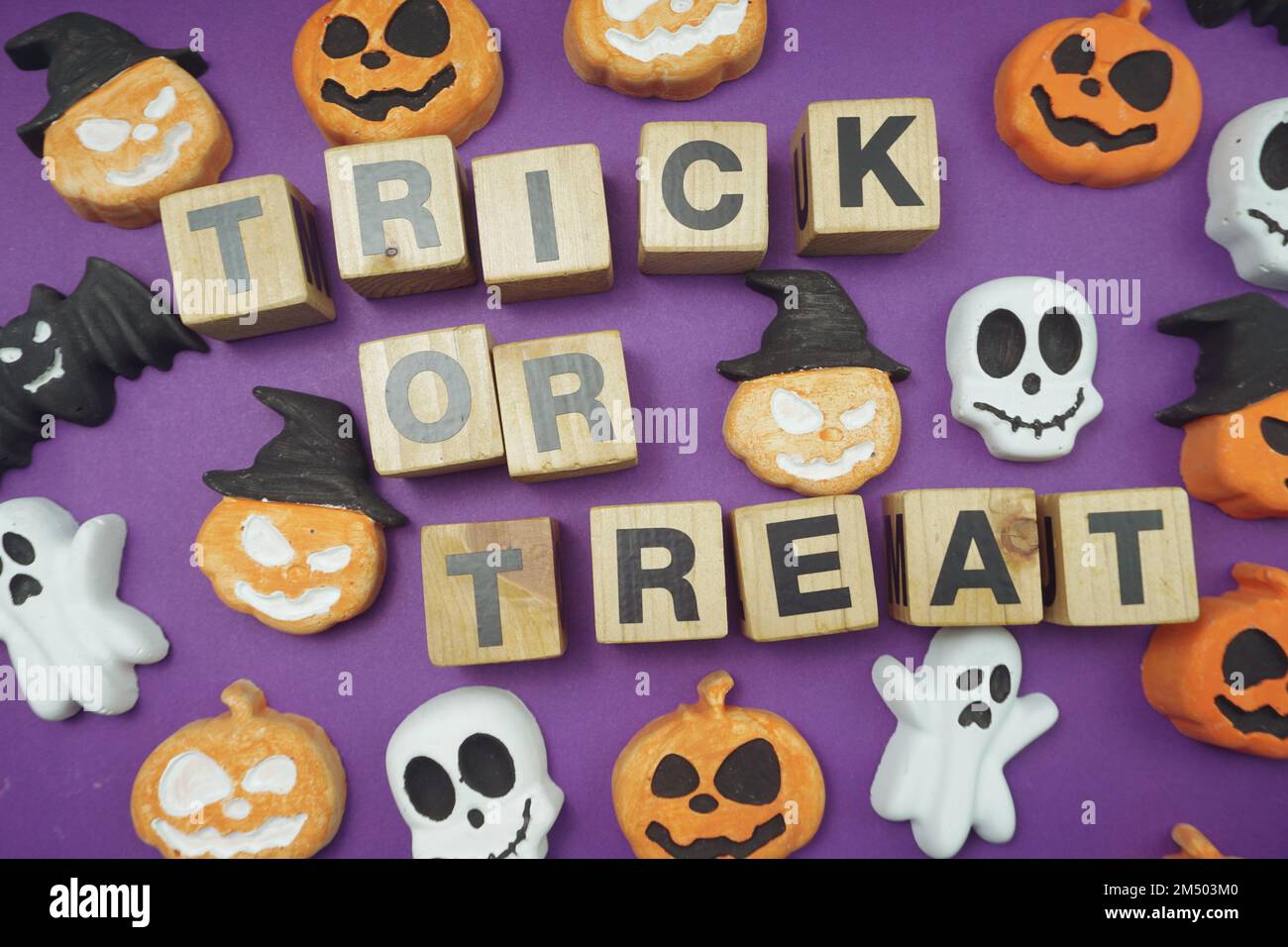 Halloween concept flat lay Trick or Treat alphabet letters on purple ...