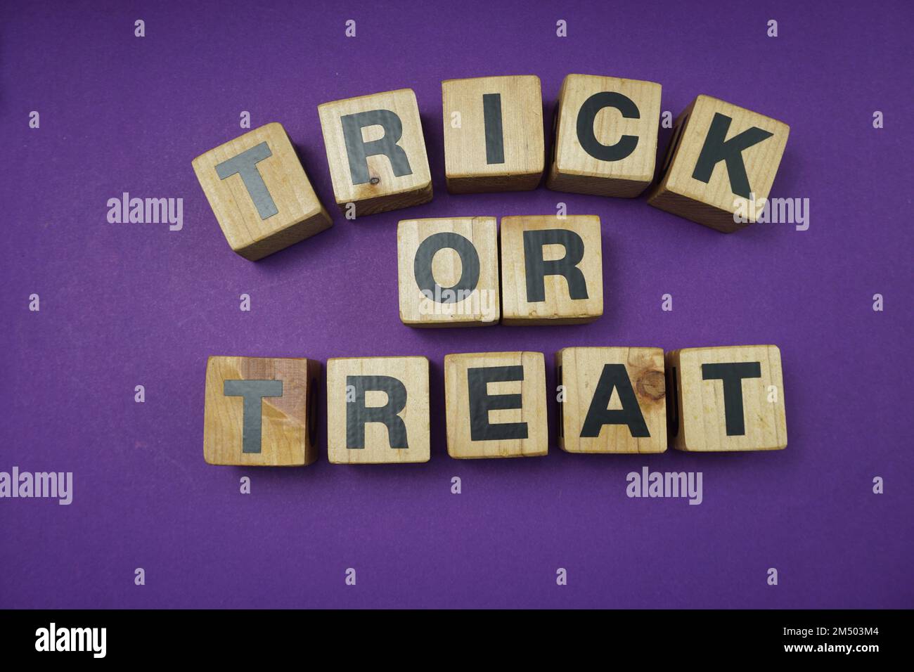 Halloween concept flat lay Trick or Treat alphabet letters on purple ...