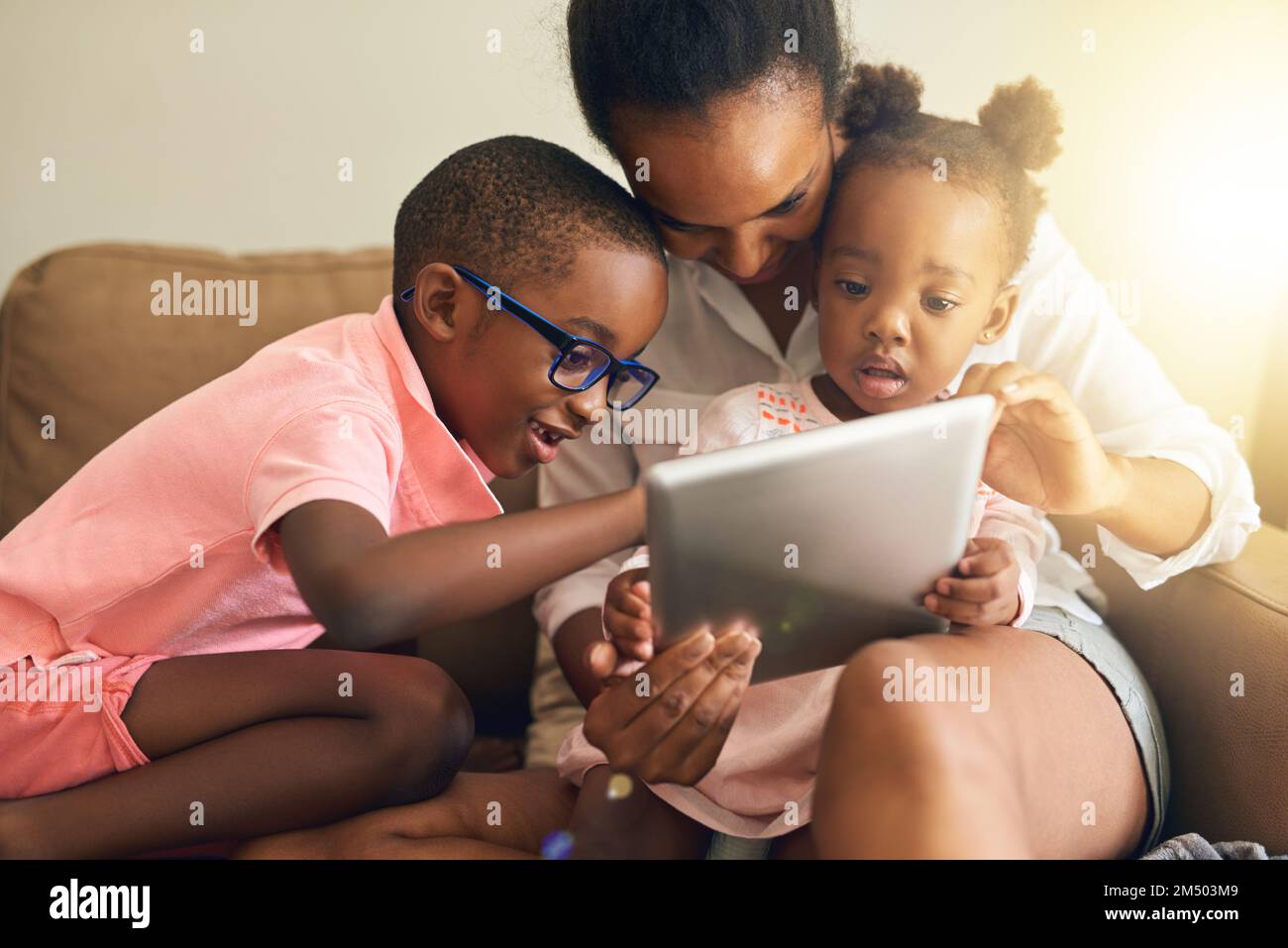 Family browsing. an affectionate young family using a tablet together ...