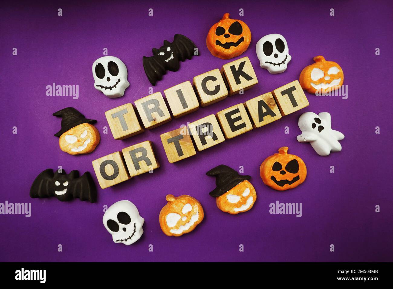 Halloween concept flat lay Trick or Treat alphabet letters on purple ...