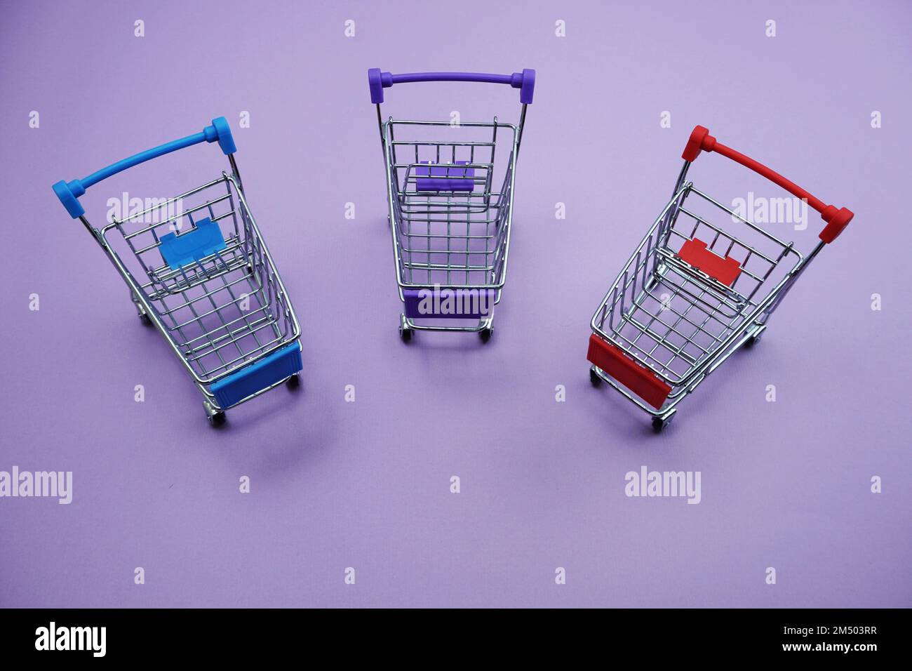 Mini trolley cart with space copy on purple background Stock Photo - Alamy