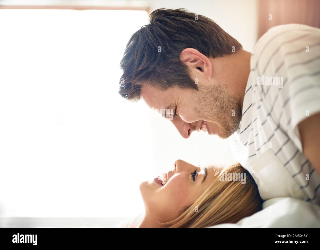 Its a love thing. an affectionate young couple gazing into each others ...