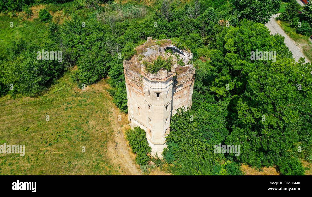 A drone shot of a water tower from 15th century surrounded by trees in ...