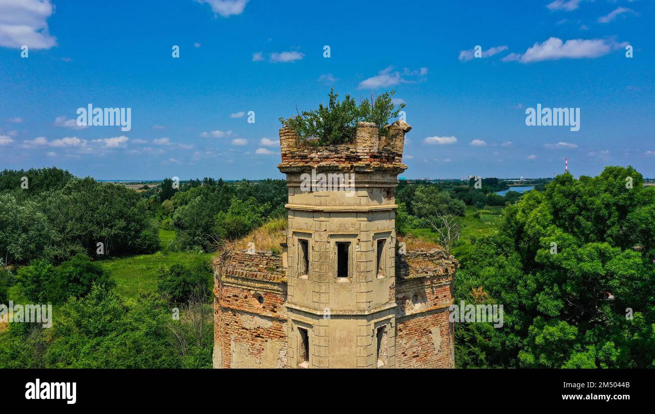 A drone shot of a water tower from 15th century surrounded by trees in ...
