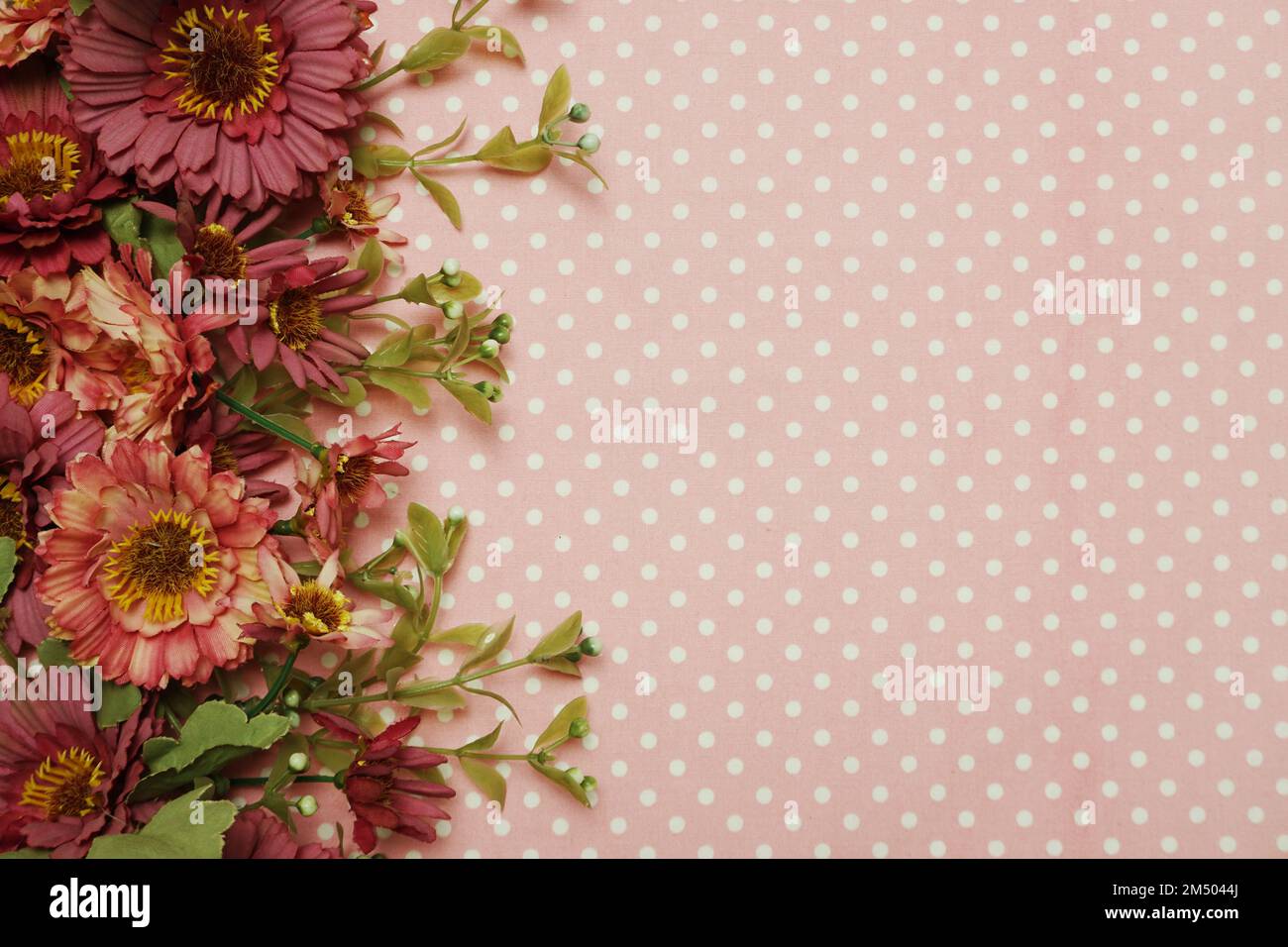 Flower border with pink polka dot background Stock Photo - Alamy