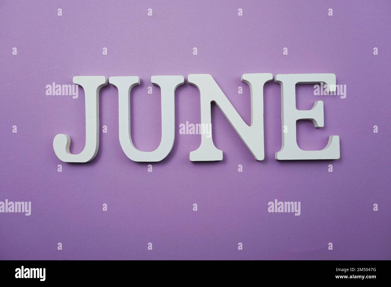 June alphabet letter with space copy on purple background Stock Photo ...