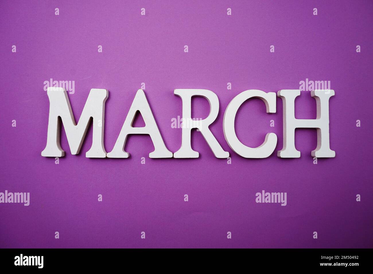 March alphabet letter with space copy on Purple background Stock Photo ...