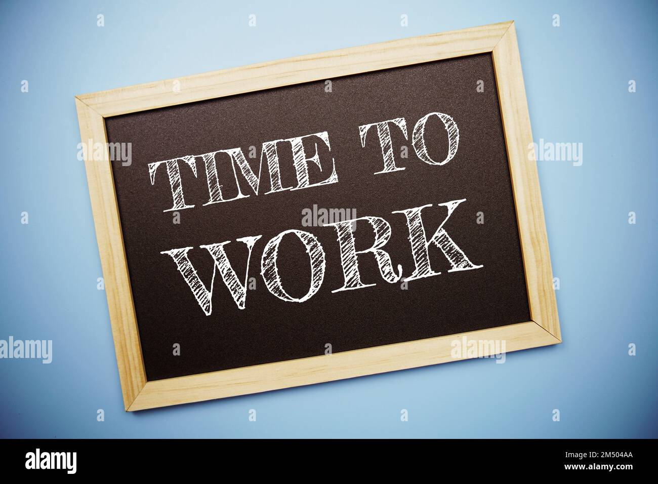 Time to Work word with alarm clock on blue background Stock Photo - Alamy